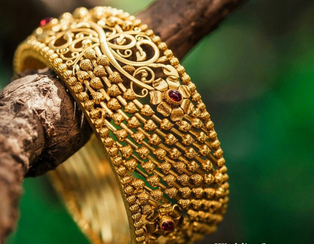 Broad golden bangles