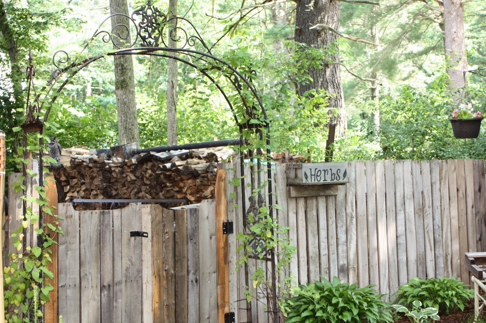 East Coast Styler : Antique Wrought Iron Arbor with a DIY Pallet Fence