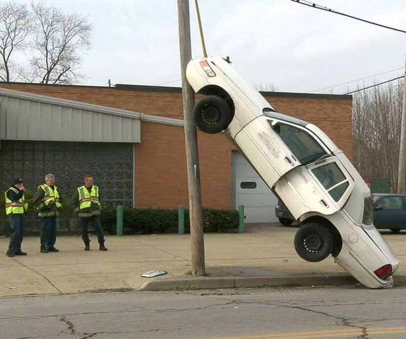 Nothing To Do With Arbroath: Distracted lady drove her car up utility pole