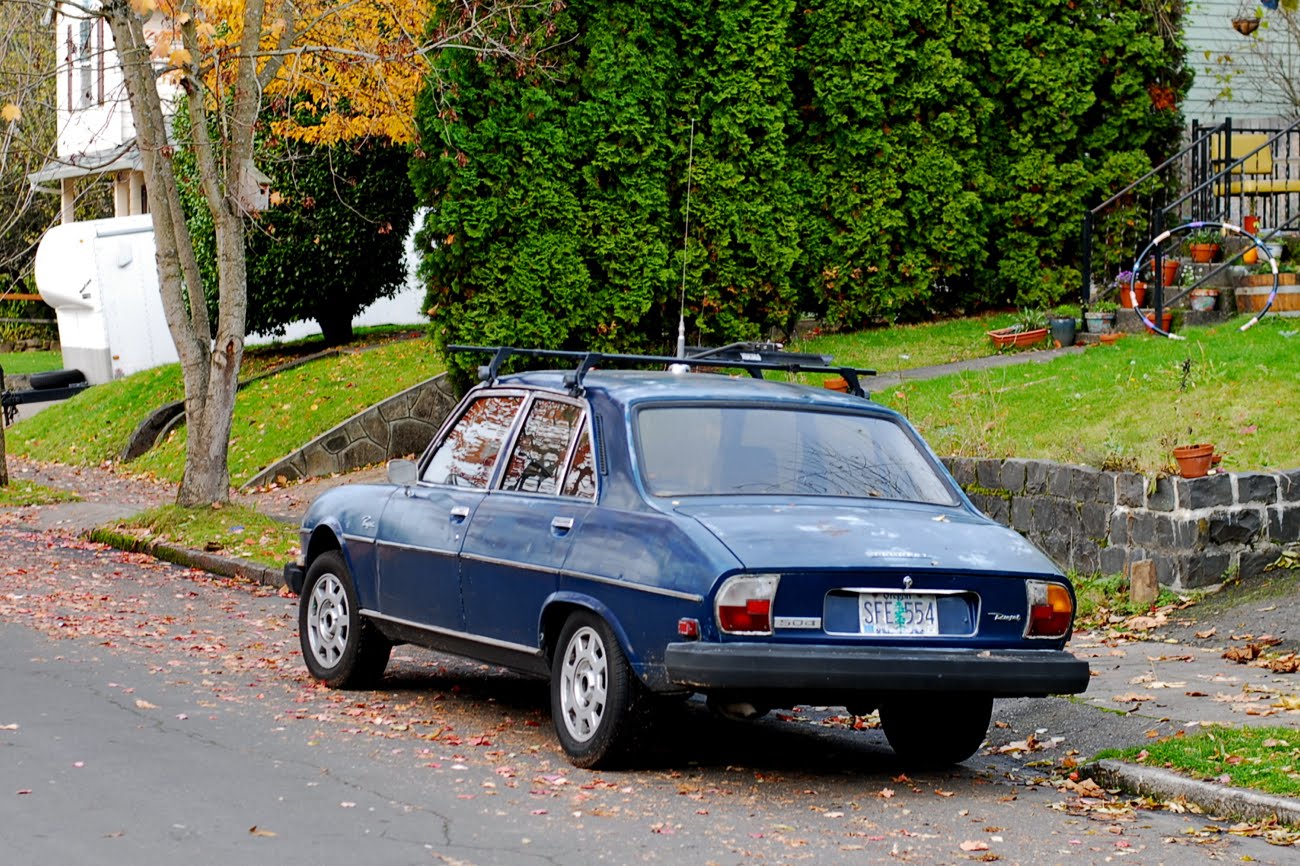 OLD PARKED CARS.: 1978 and 1979 Peugeot 504 Diesel Sedans.