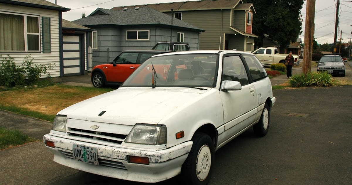 OLD PARKED CARS.: 1988 Chevy Sprint.