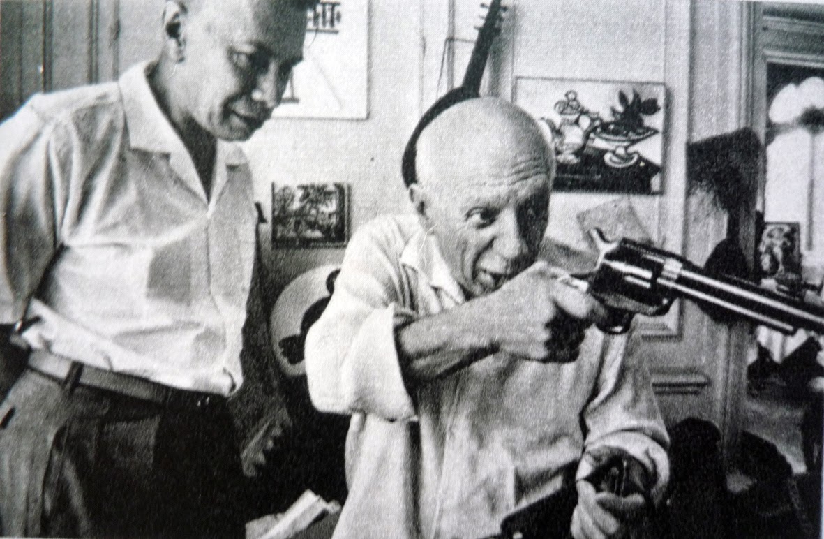 Pablo Picasso wearing a hat and holding a revolver & holster given to ...