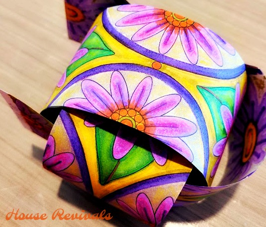 When both ends of the last strip are threaded through, and around, the ...