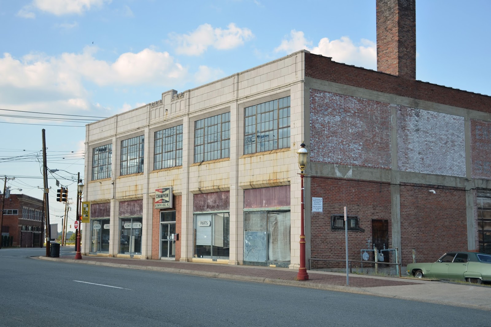 There's a forgotten car hanging out next to the building. It's almost ...