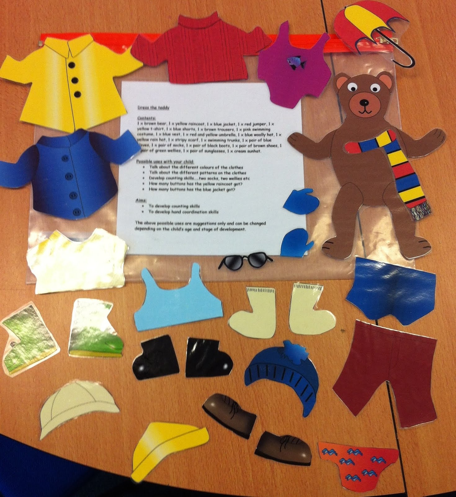 Early language skills through play.......: Dress the teddy....
