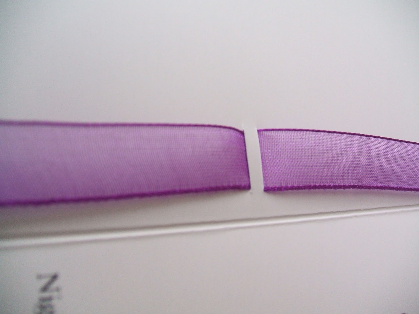 say it says: How to tie a ribbon round a card