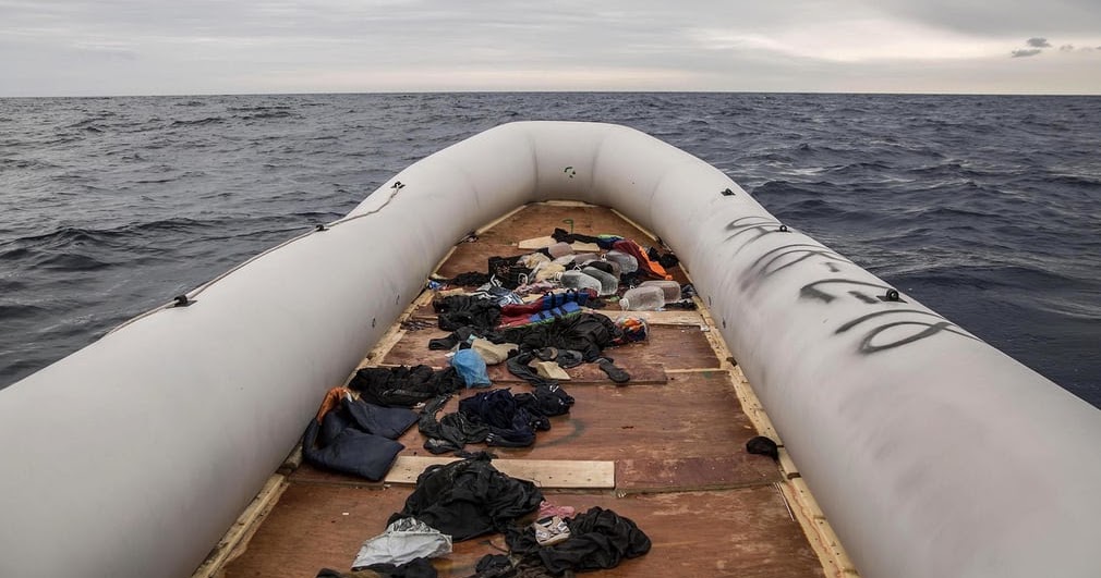 Migrants and refugees’ personal belongings lie on a rubber boat