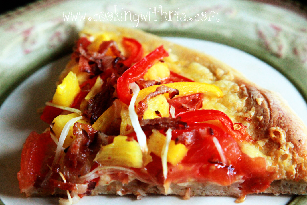 Pizza with veggies and bacon.....and Oprah...