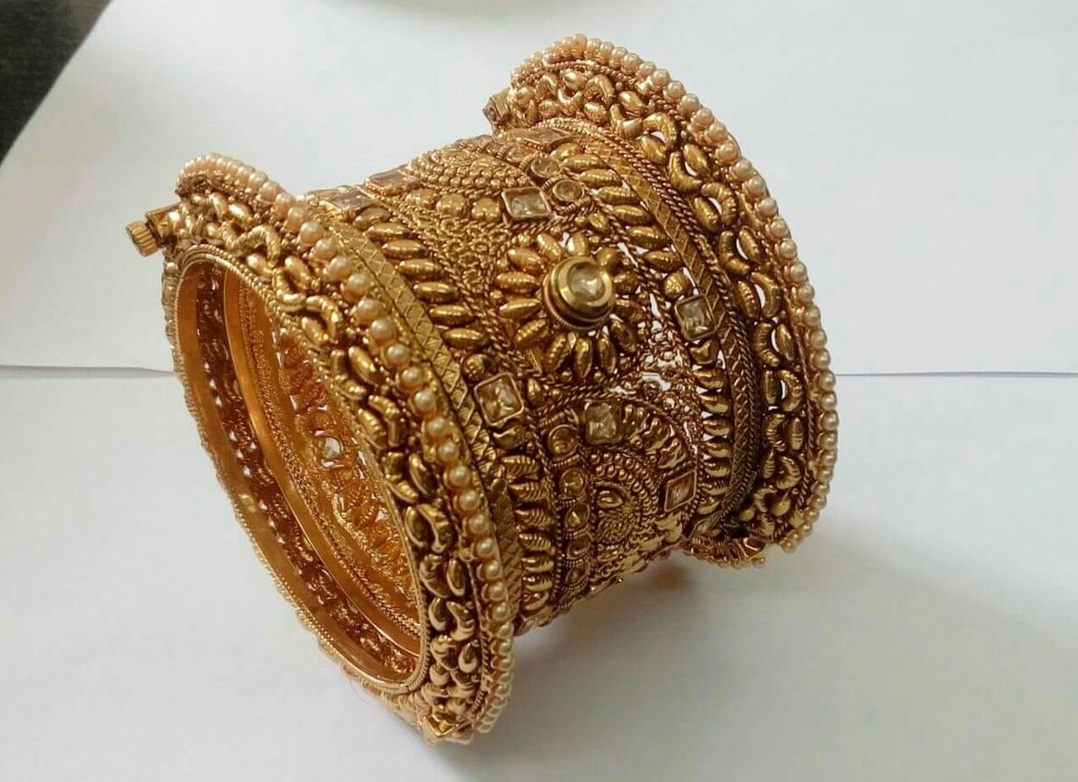 Broad golden bangles