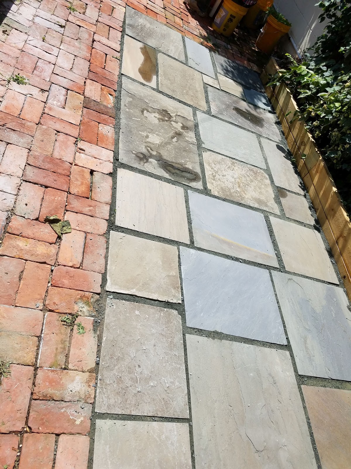 Custom Stoneworks & Design Inc.: Flagstone section in existing brick patio