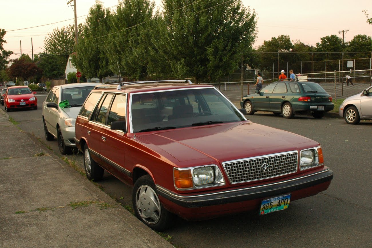 OLD PARKED CARS.: 1987 Plymouth Reliant K SE Wagon.