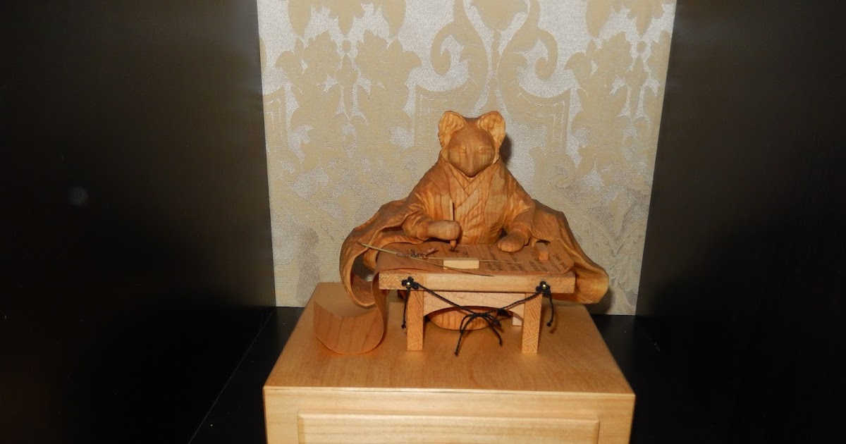 Woodcarving by Hannah Woodward: Fox 1 (The fox practices calligraphy.)