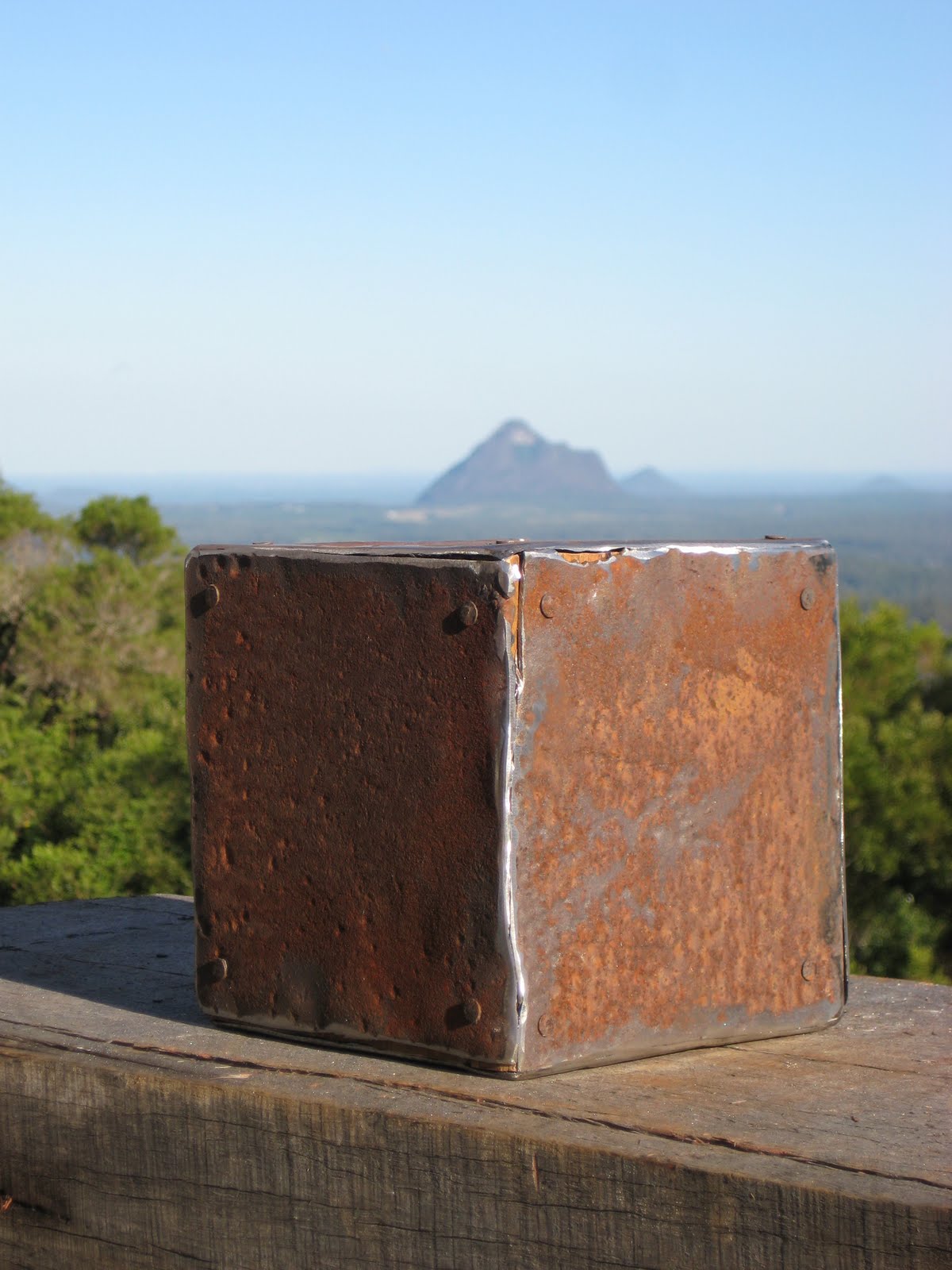 Rustnstuff: Rusted cube with mountain