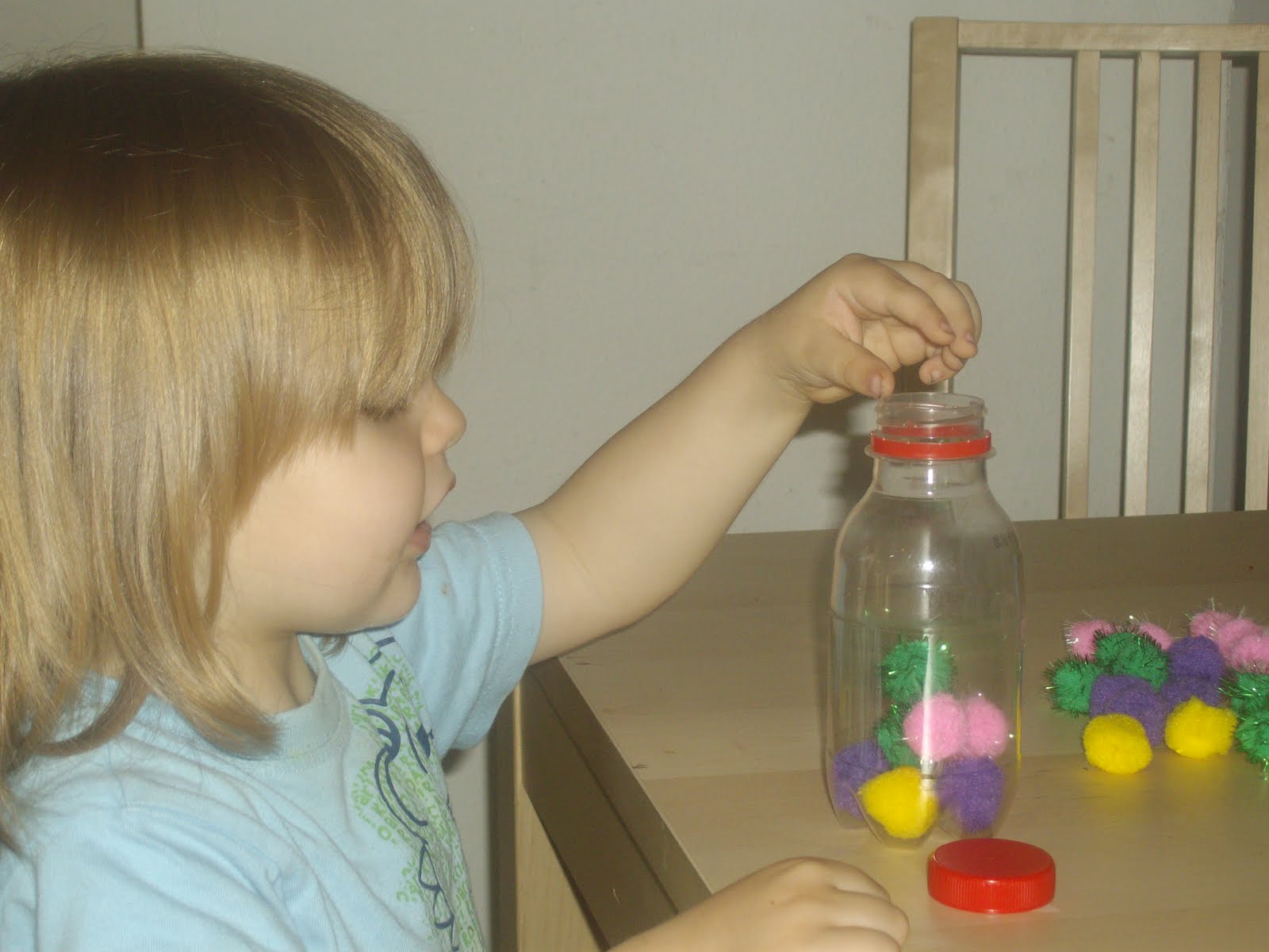 Muck Monsters: Fine Motor Skills: pom-poms in a bottle