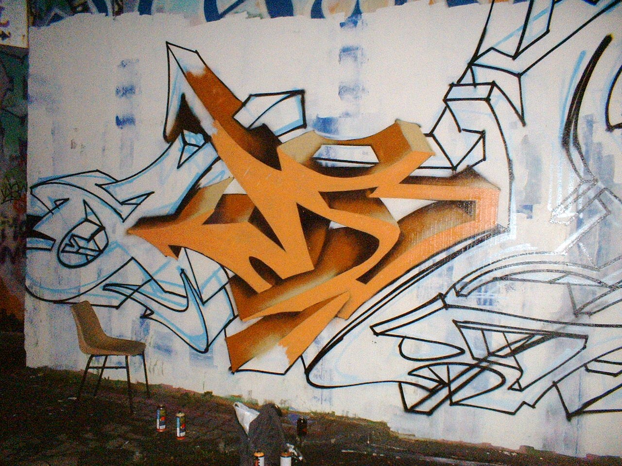 Create 3d Graffiti With The Motives And Character Of Yellow White Wildstyle On A Wall Of Natural