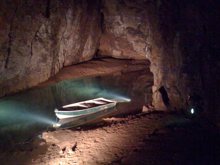 Alicia Merrett: Boat on the subterranean river in the Wookey Hole caves
