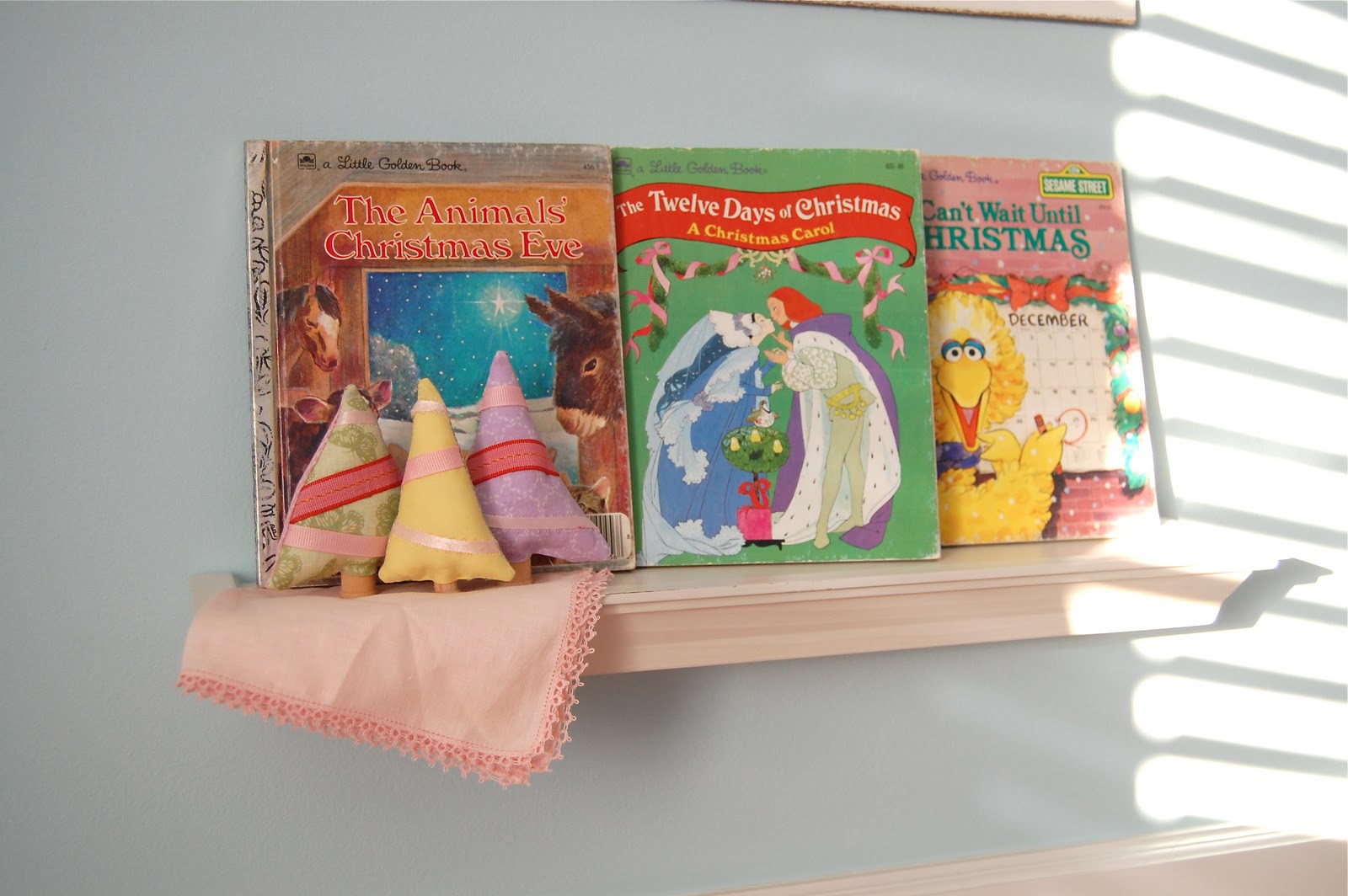 their little golden book shelf is filled with christmas books and their ...