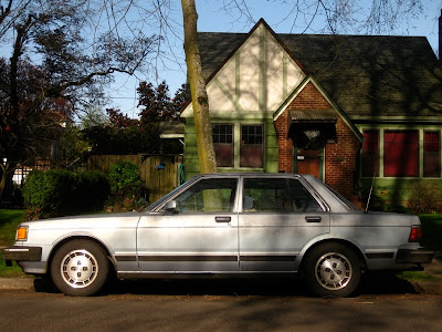 OLD PARKED CARS.: 1984 Nissan Maxima.