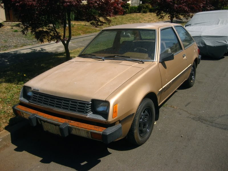 OLD PARKED CARS.: 1980 Dodge Colt Hatchback.