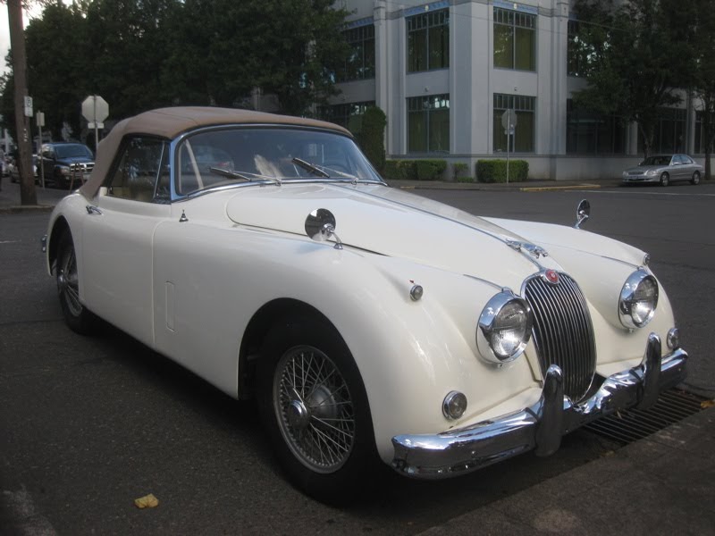 OLD PARKED CARS.: 1961 Jaguar XK150 Convertible.