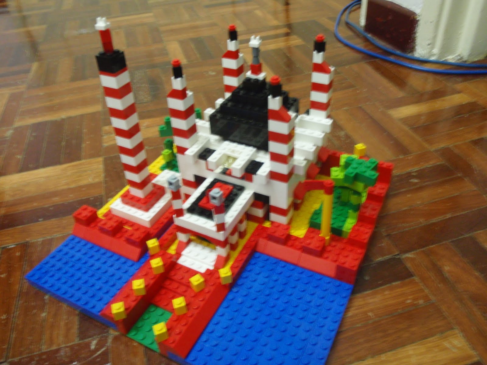 BUANASENI: RED & WHITE MOSQUE WITH A BLACK DOME