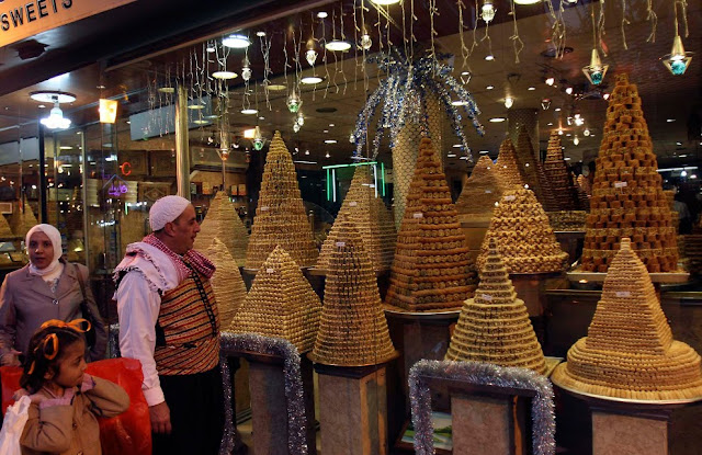 *mystylenews*: Syrians look at stacks of sweets displayed in ...