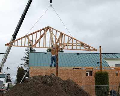 Expanding the farm at Bow: Trusses delivered in wind and rain.
