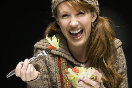 Women laughing alone with salad