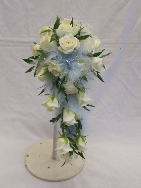 RJ's Florist: White rose and pale blue feather brides bouquet.